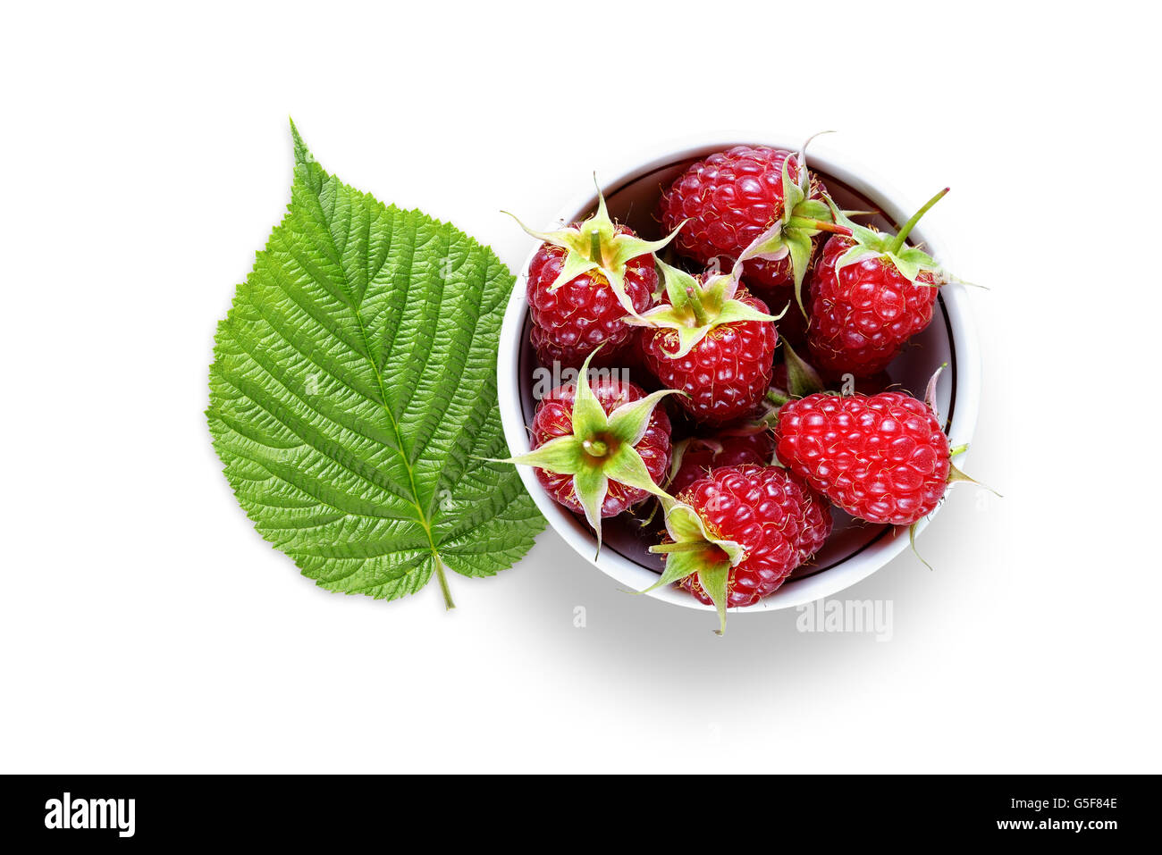 Raspberry in bowl and green leaf isolated on white background Stock ...