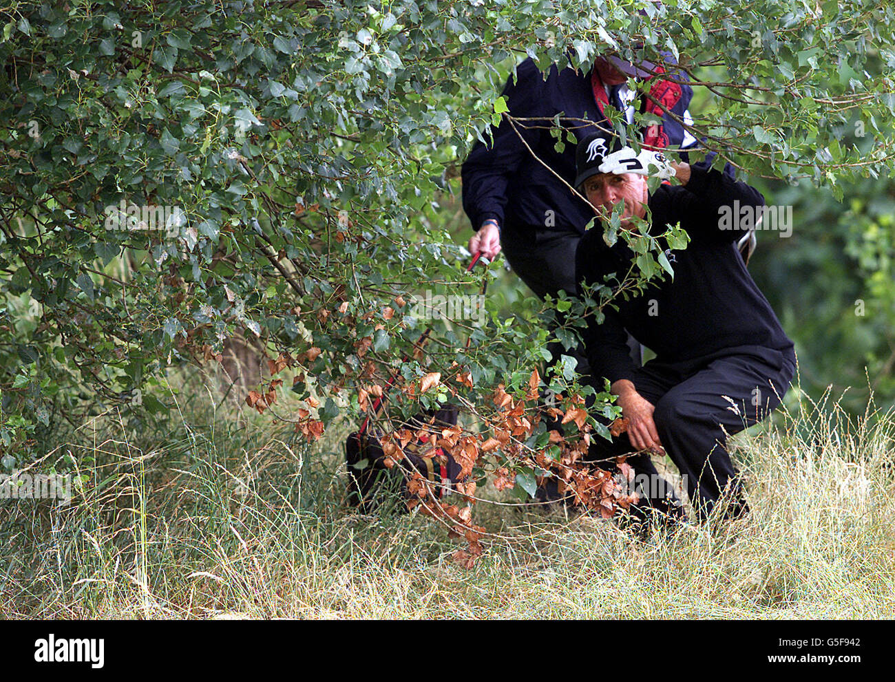South Africa's Gary Player looks for his ball in the rough during the ...