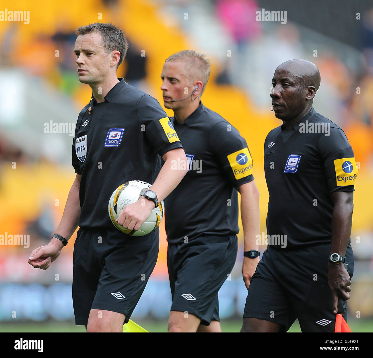 Referee Stuart Attwell (far left) walks off the pitch at half time with ...