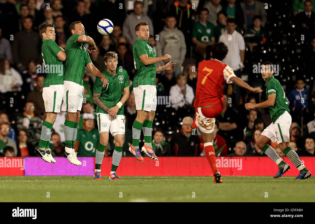 Republic of Ireland players jump in the defensive wall Stock Photo - Alamy
