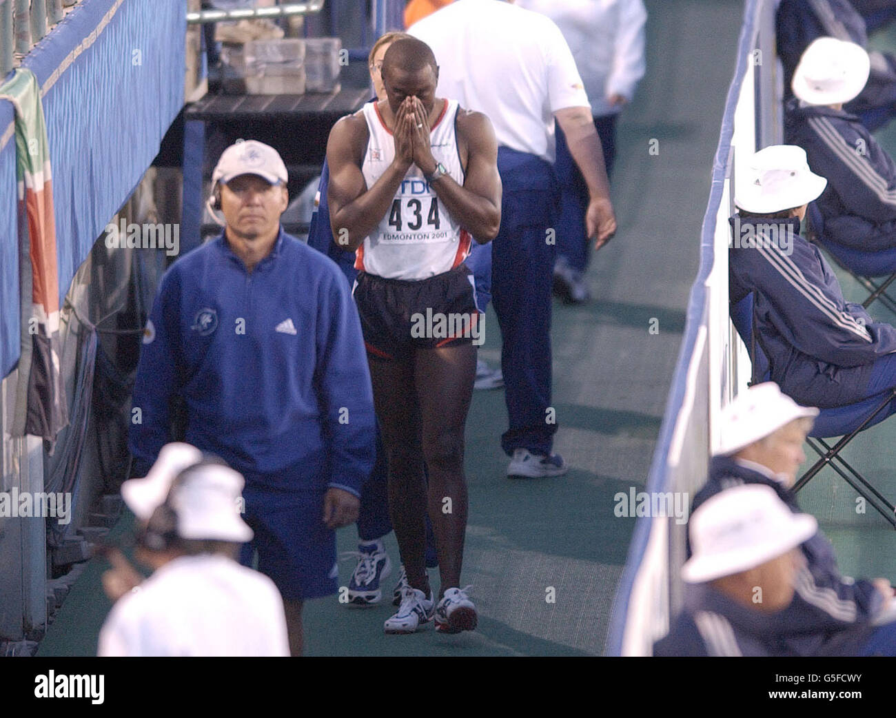 Great Britain's Tony Jarrett (number 434) leaves the track after being ...