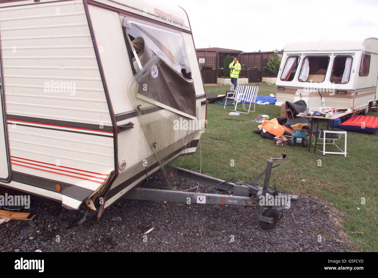 A worker surveys the wreckage of two caravans at the Kingfisher Caravan ...