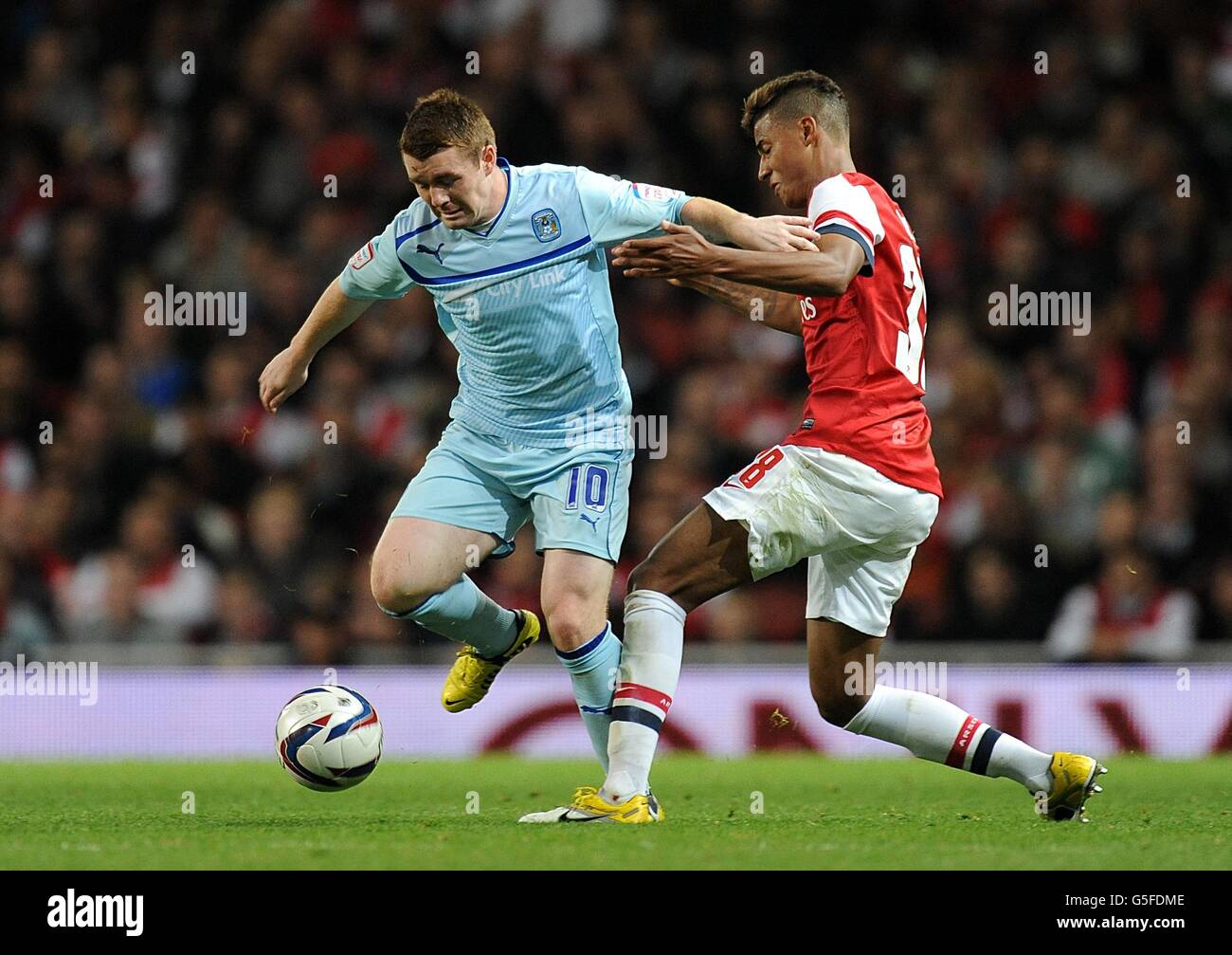 Coventry City's John Fleck (left) and Arsenal's Martin Angha in action ...