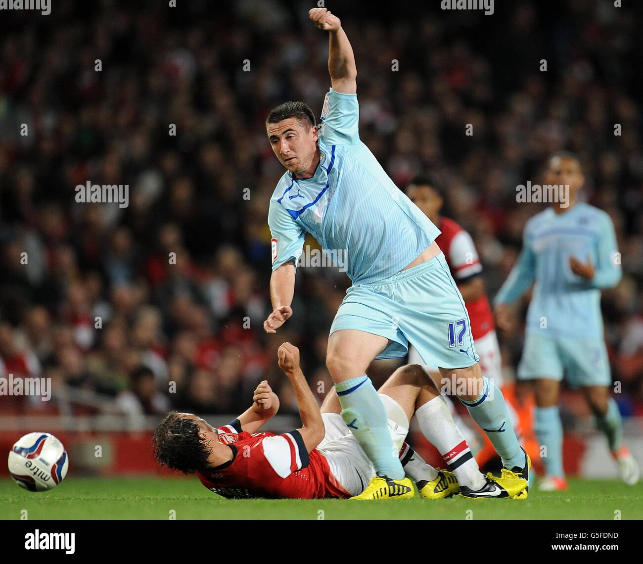 Coventry City's Callum Ball (right) skips past Arsenal's Ignasi Miquel ...