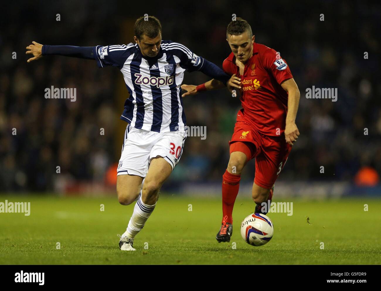Liverpool's Samed Yesil holds off West Bromwich Albion's Gabriel Tamas ...