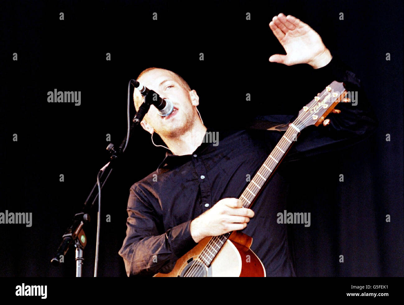 Chris Martin, lead singer of pop group Coldplay, performing on stage at ...