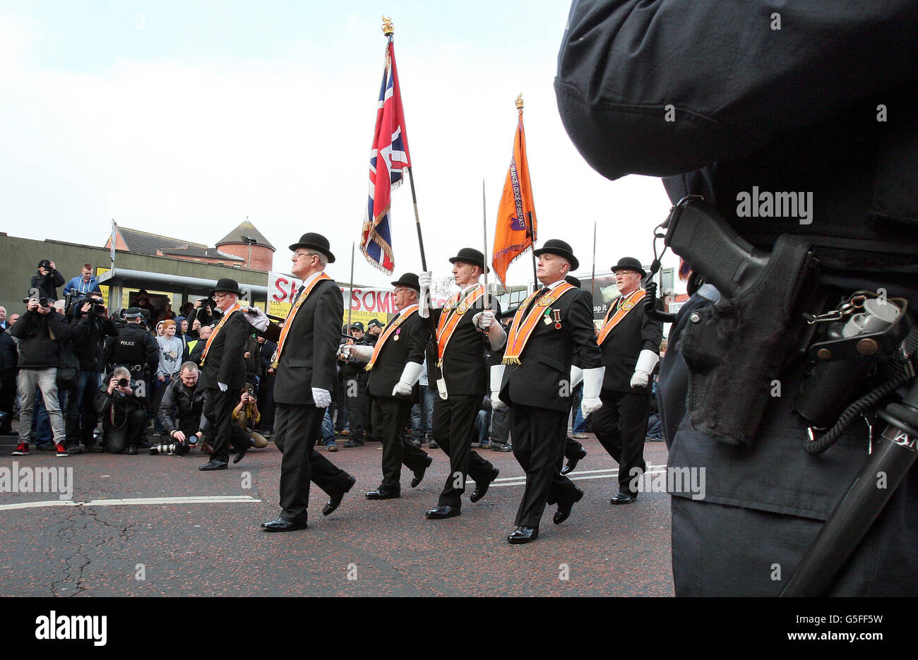 Orange Order members march passed St Patrick's Church in Belfast ...