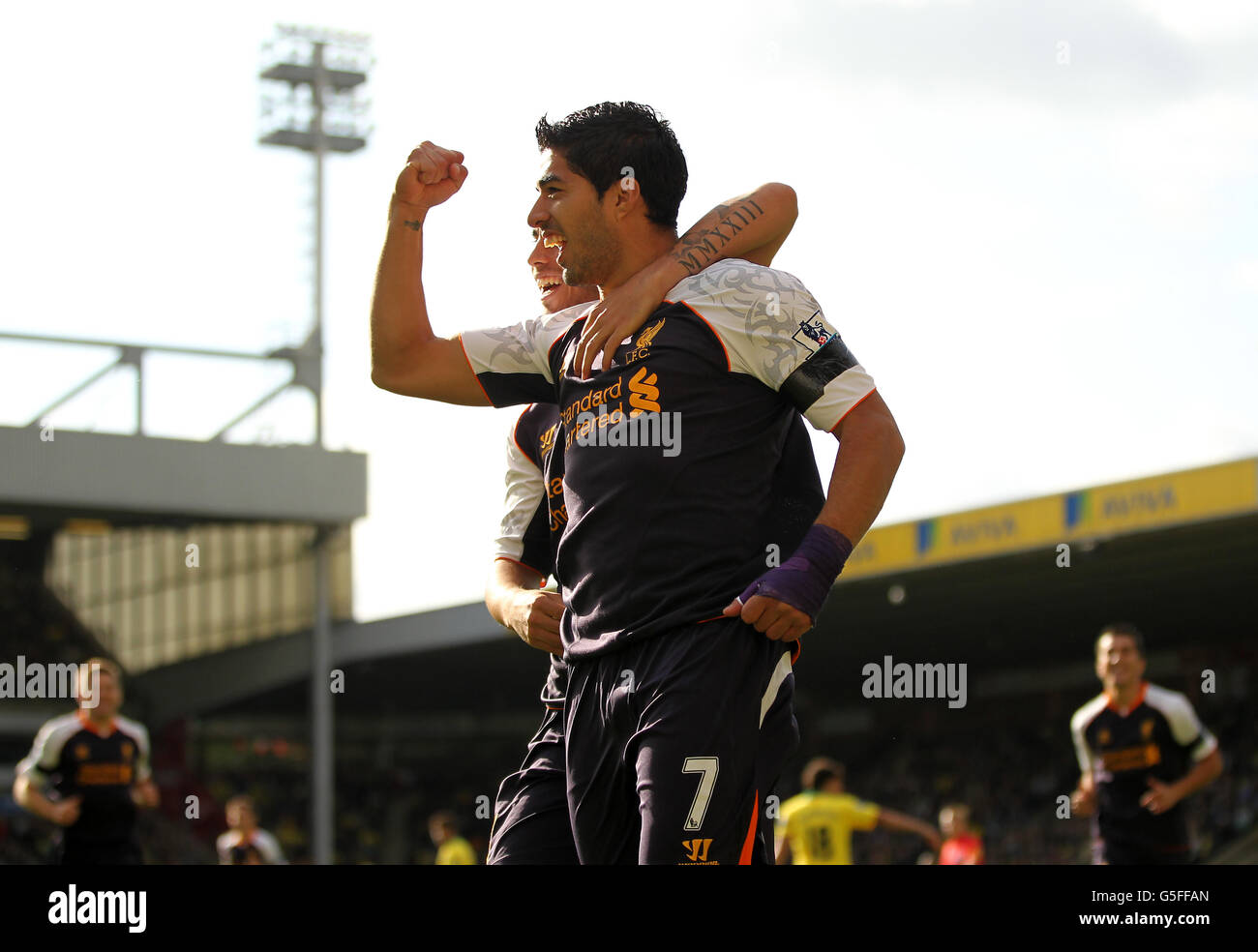 Liverpool's Luis Suarez celebrates scoring with team mate Jesus ...