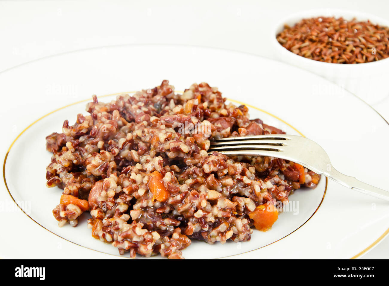 Pilaf with Meat, Carrots and Red Rice Stock Photo - Alamy