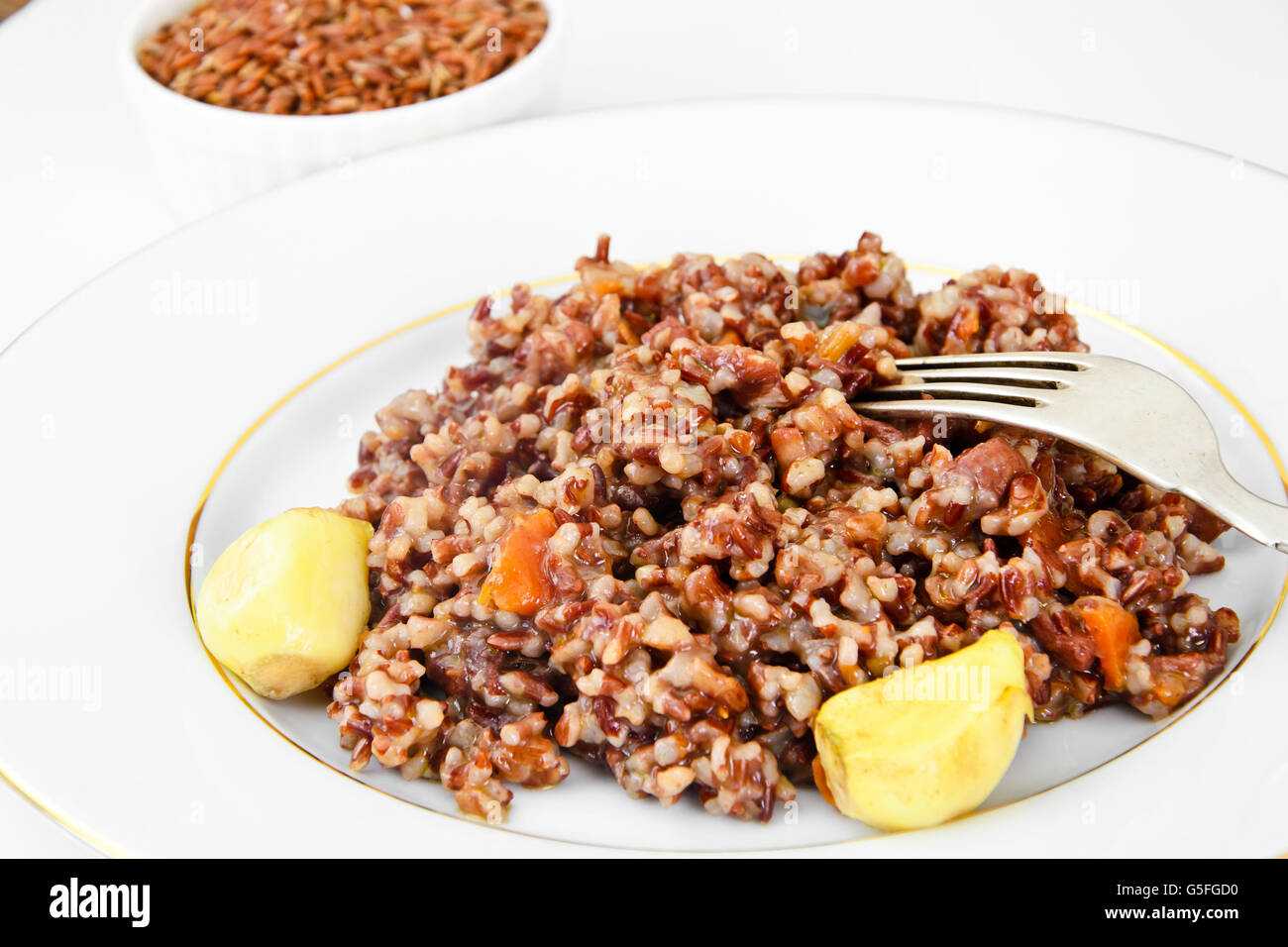 Pilaf with Meat, Carrots and Red Rice Stock Photo - Alamy