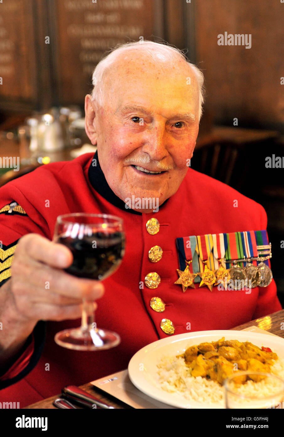 Chelsea Pensioner Eric Rawlinson aged 88, raises his glass as he joins ...