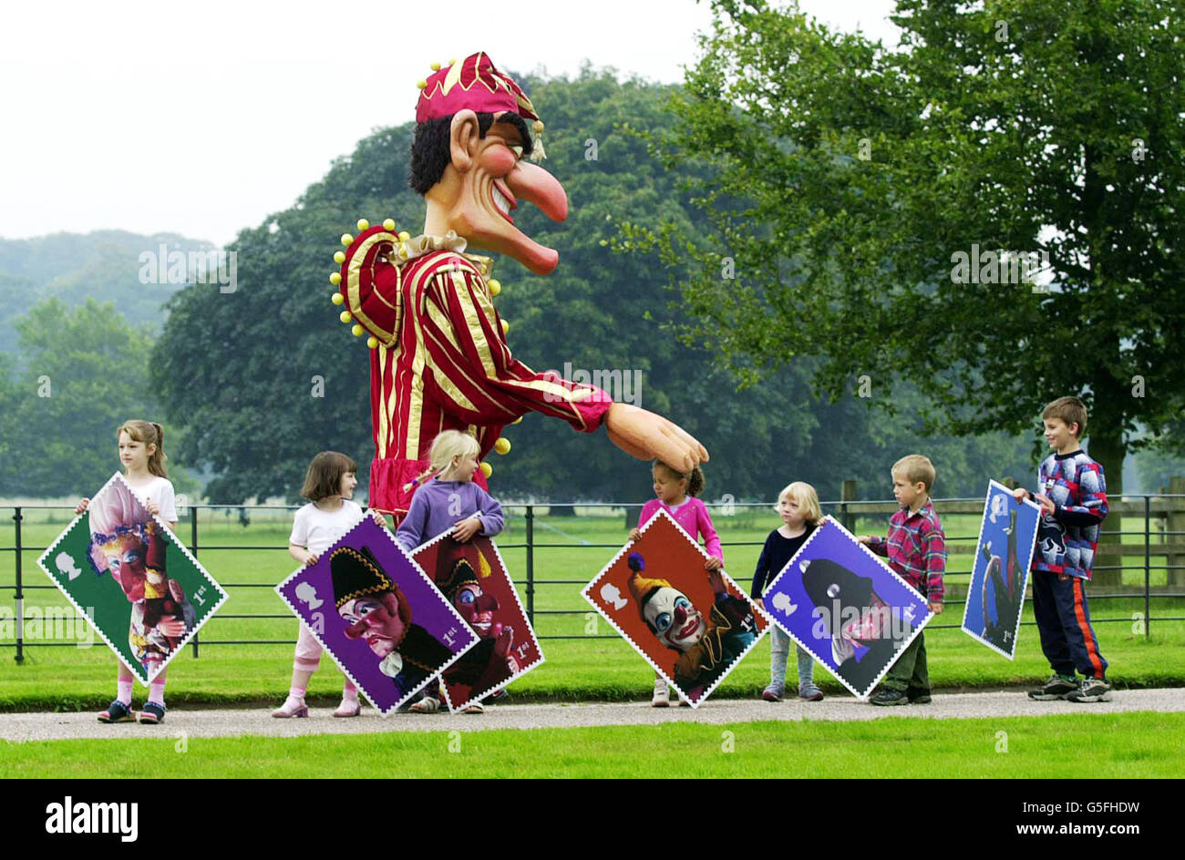 A giant sized Mr. Punch greets his young helpers, whose parents work at ...