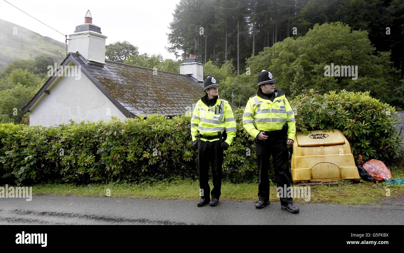 Welsh Police Officers stand outside a house called 'Mount Pleasant' in ...