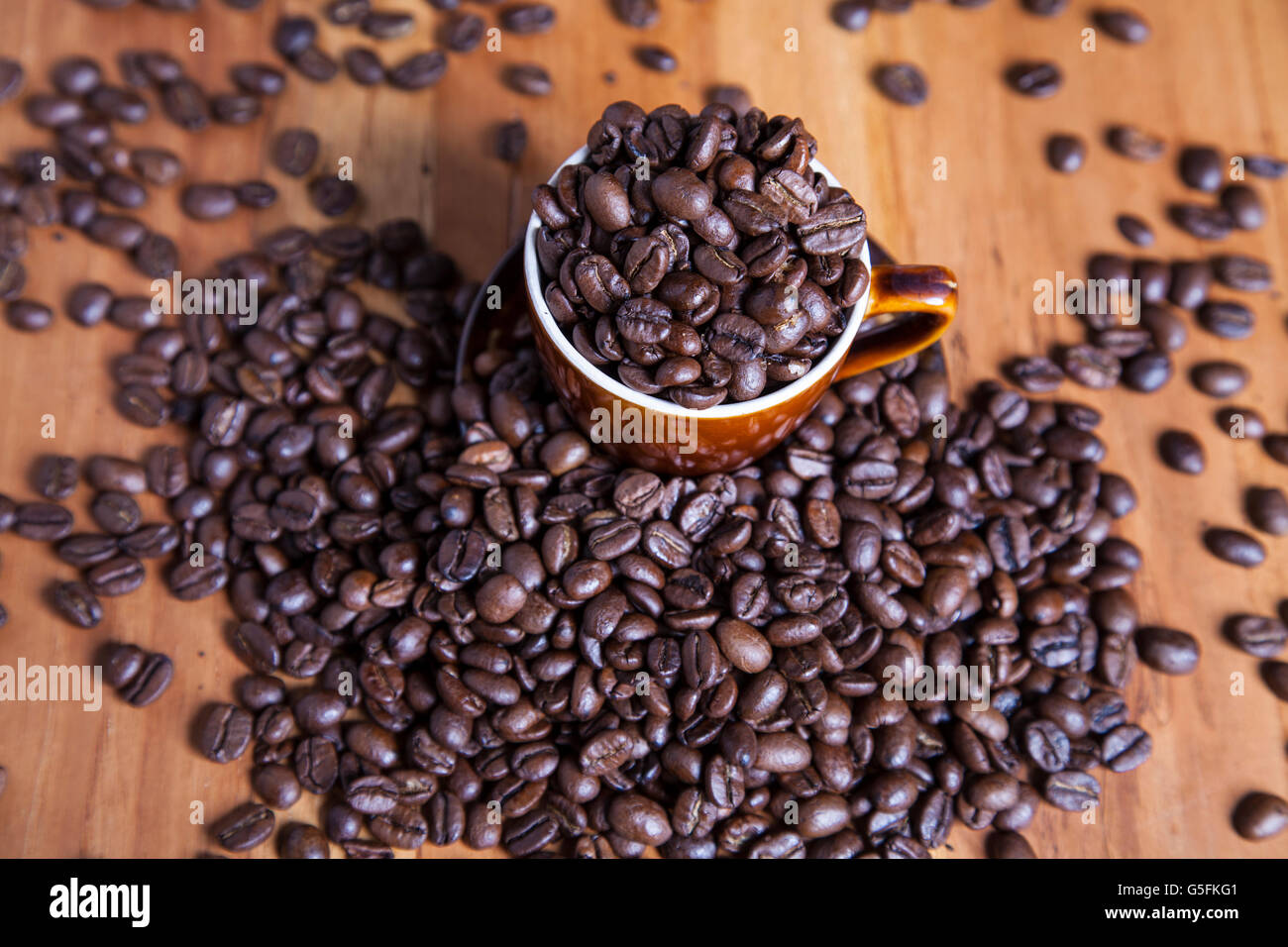 spilled coffee beans on the table Stock Photo - Alamy