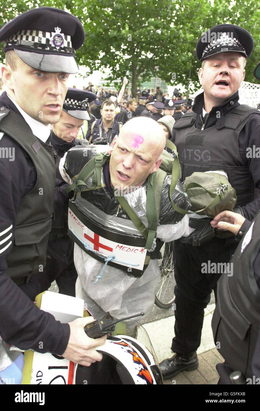 A group of Police officers arrest a demonstrator, as a protest march ...