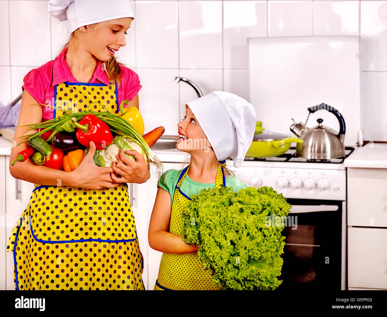 Children little girl cooking vegetables at kitchen Stock Photo - Alamy