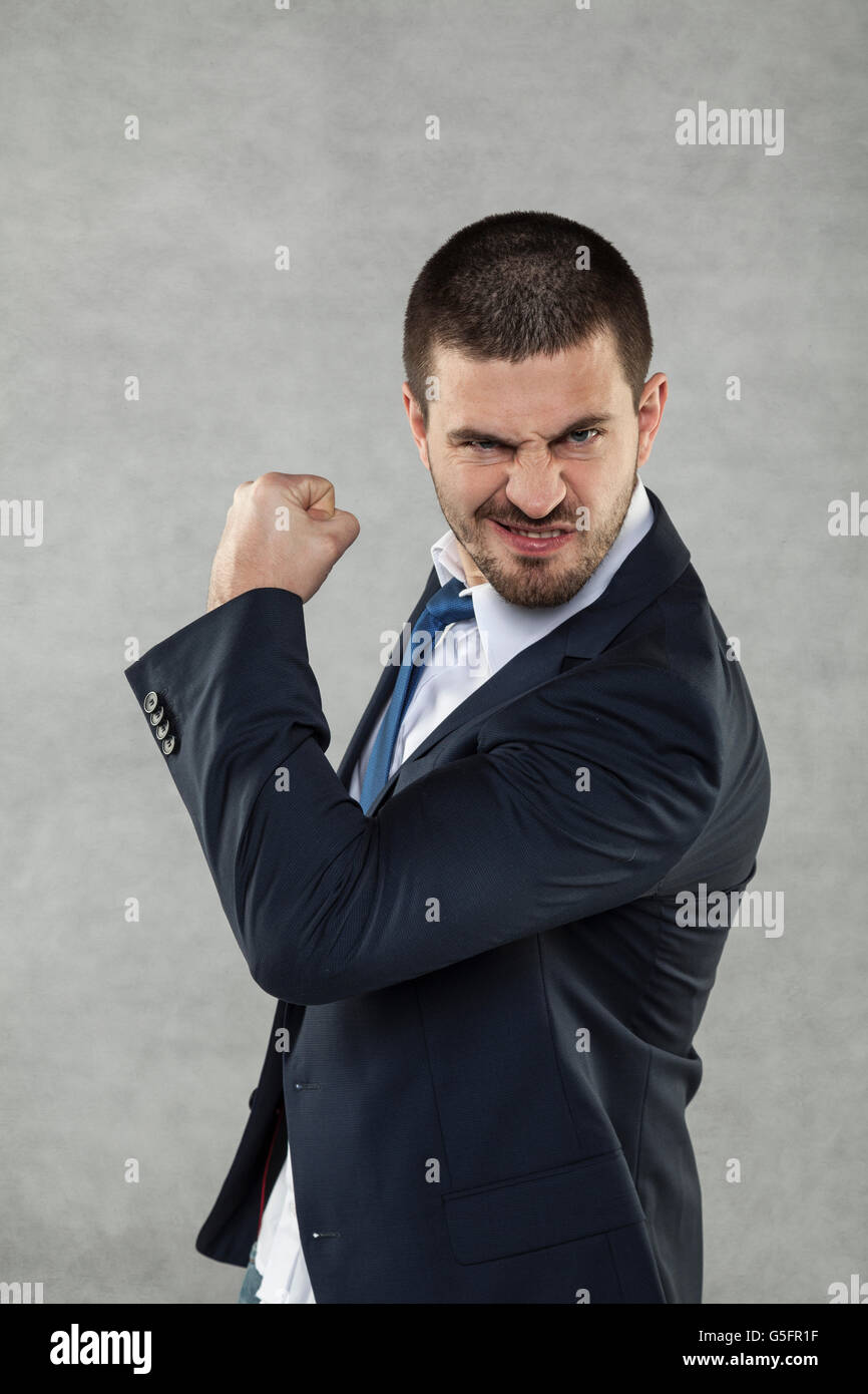 Strong business man flexing muscle hi-res stock photography and images ...