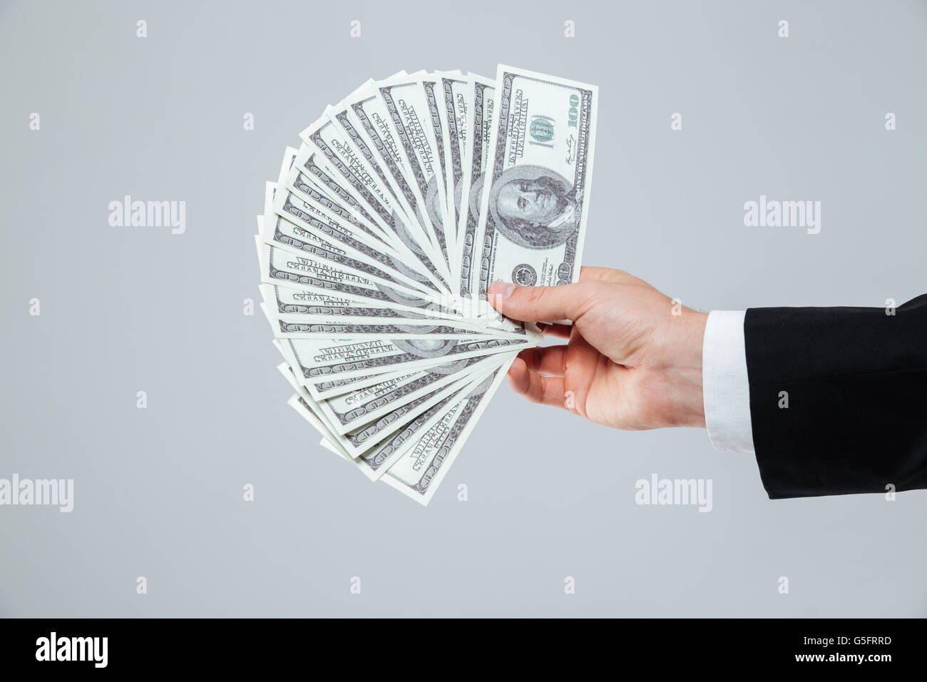 Closeup of hand of businessman holding money over white background ...