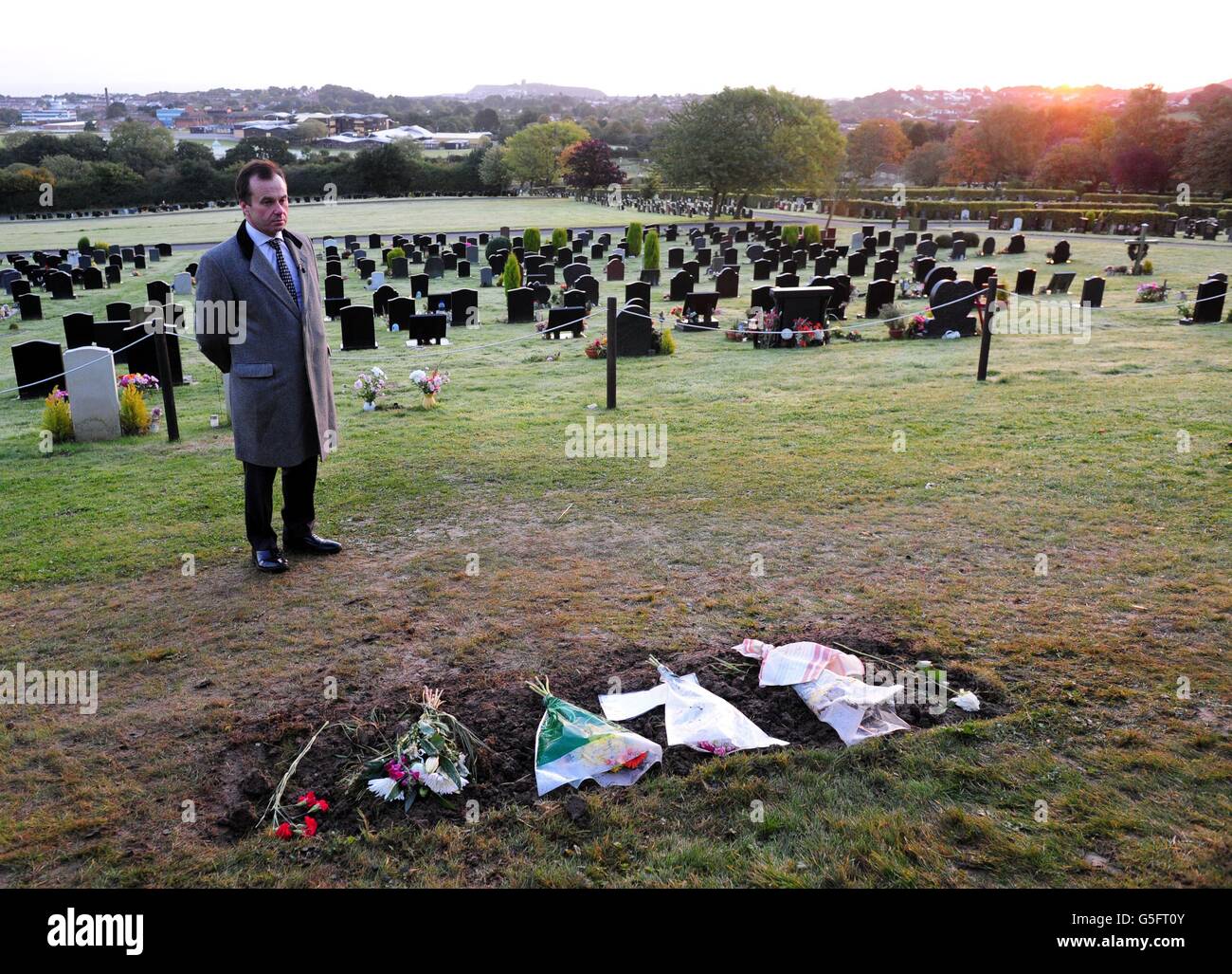 Funeral director Robert Morphet stands next to the grave of Sir Jimmy ...
