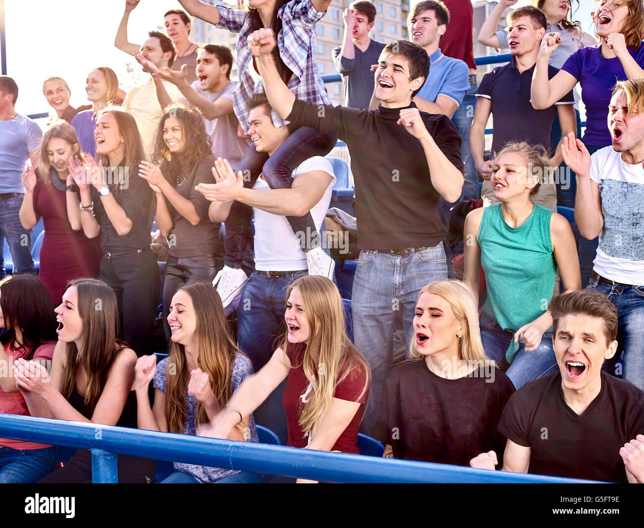 Sport fans hands up and singing on tribunes Stock Photo - Alamy