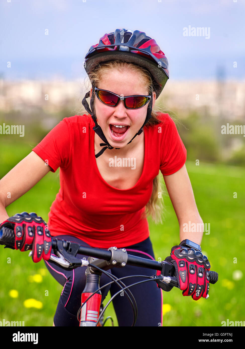 Bicyclist girl rides bicycle out city Stock Photo - Alamy