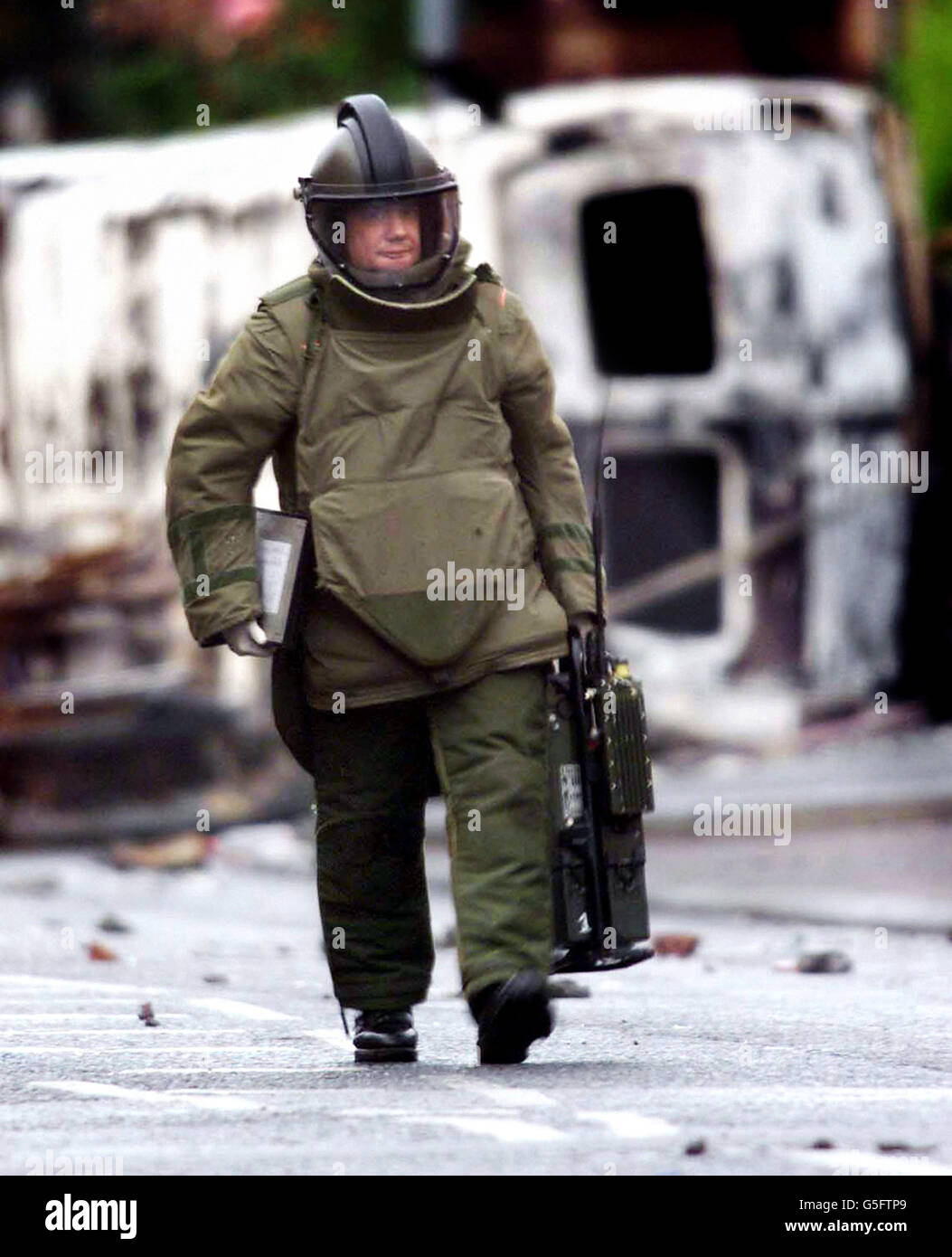 Army bomb disposal expert prepares to examine a pipe bomb just off the ...