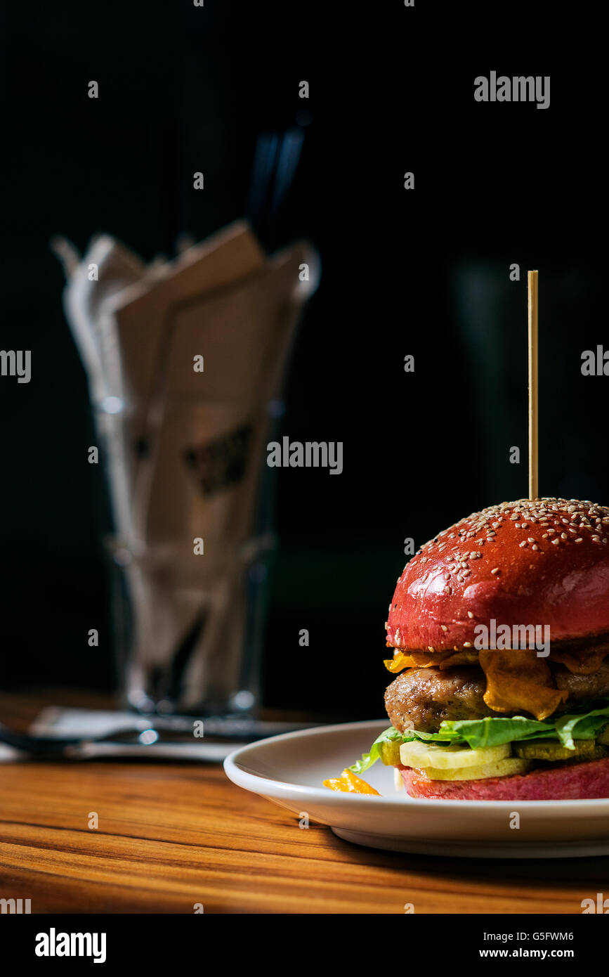 modern gourmet trendy chicken burger in beetroot bun Stock Photo - Alamy