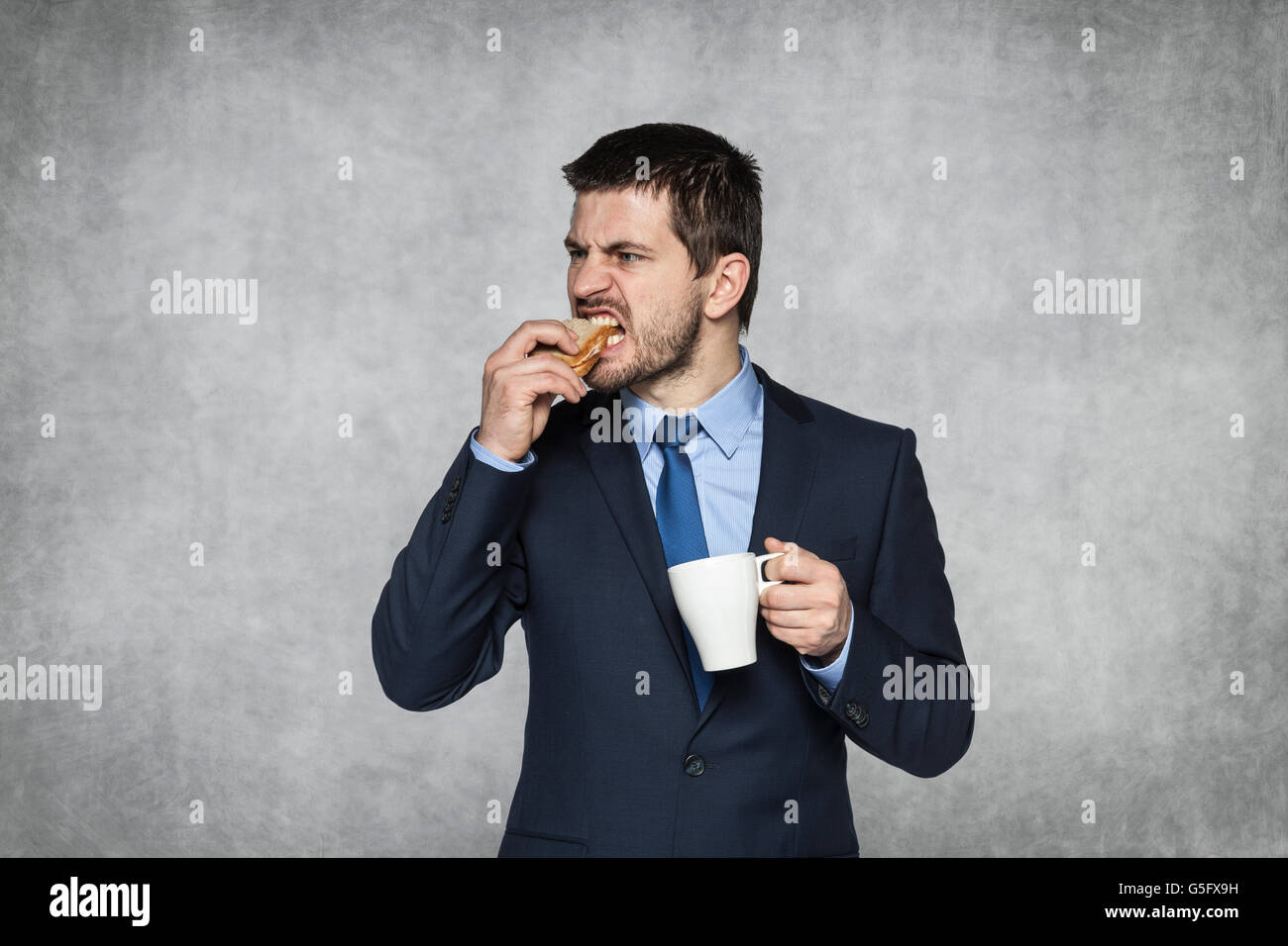 businessman biting a sandwich Stock Photo - Alamy