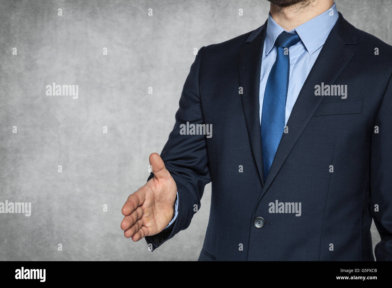 businessman holds out his hand to greet Stock Photo - Alamy