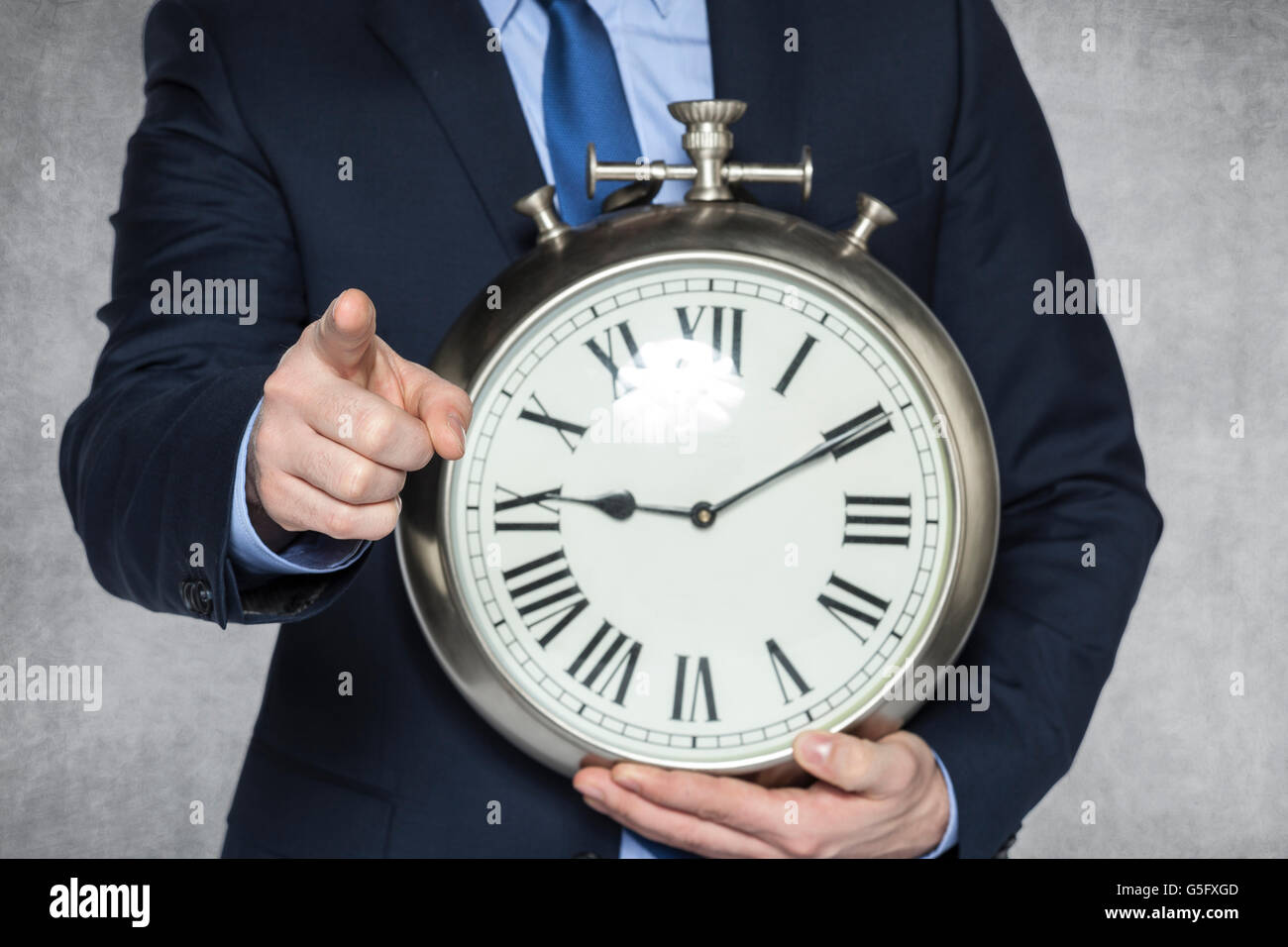businessman with clock pointing at you Stock Photo - Alamy