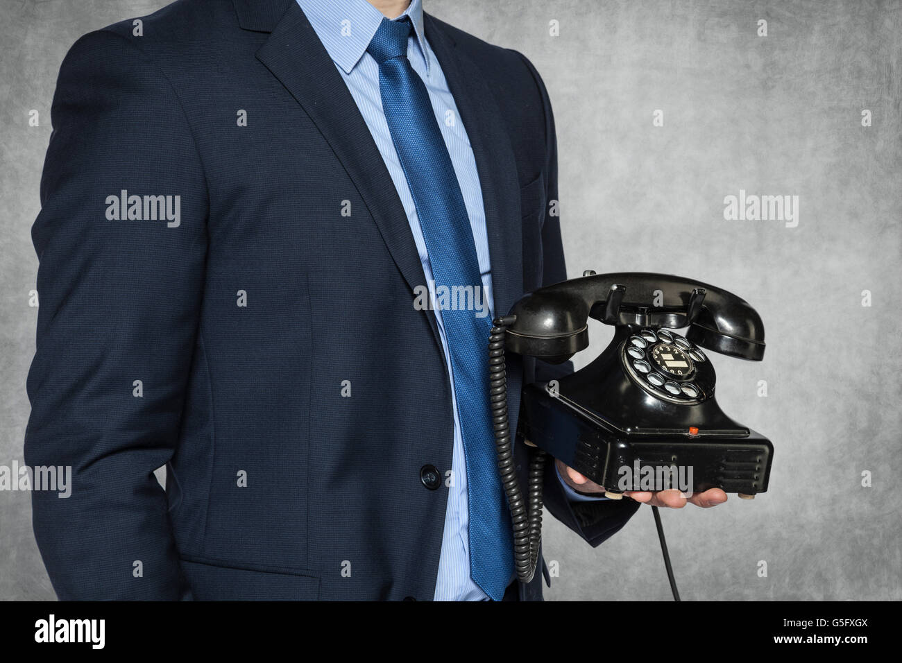 businessman presenting phone Stock Photo - Alamy