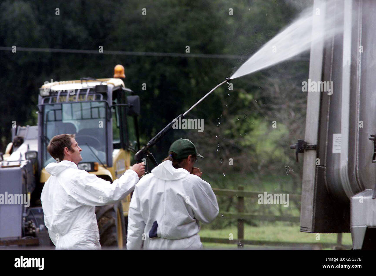 Farm lorries for carrying cattle are sprayed with disinfectant as ...