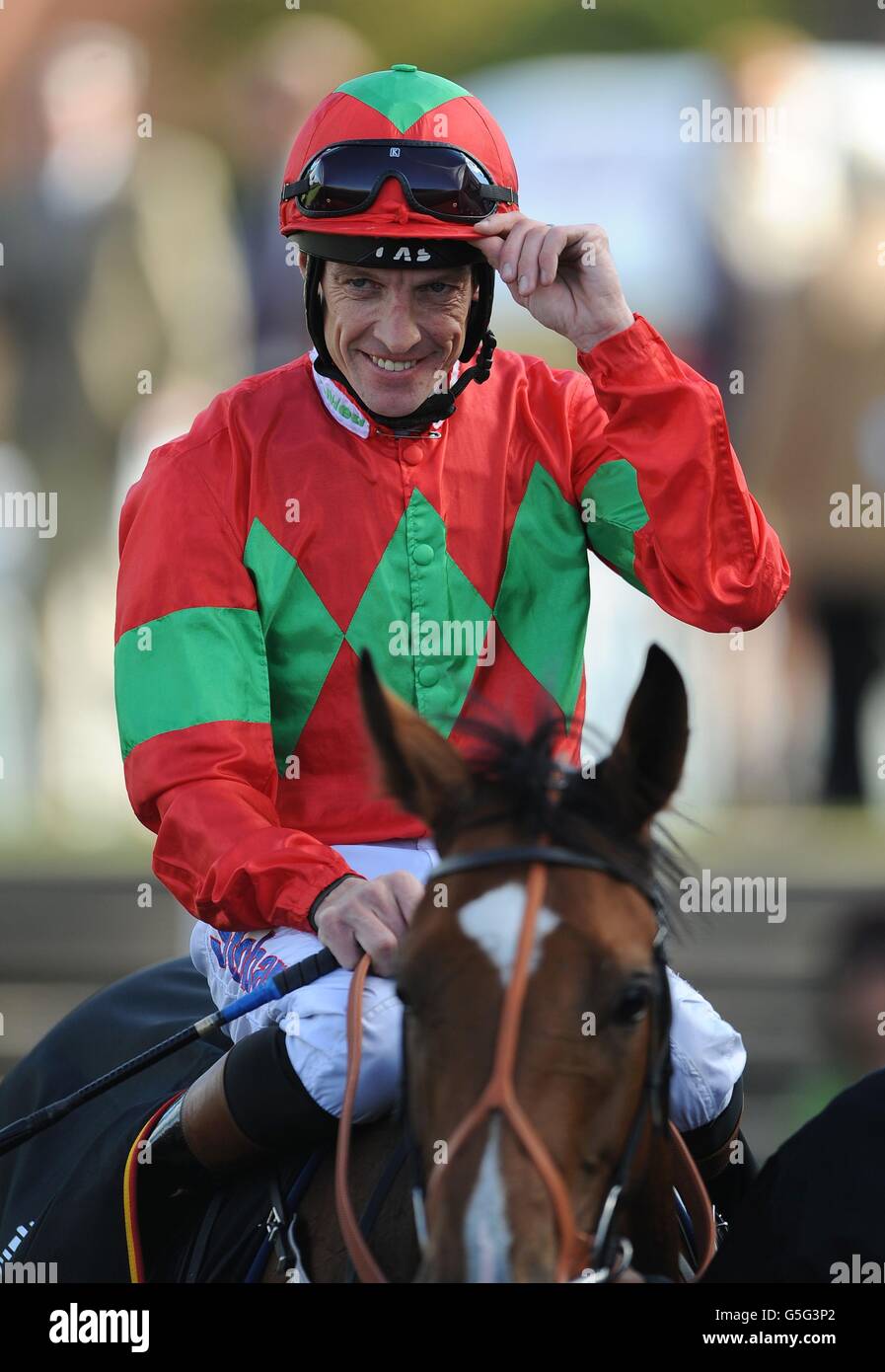 Richard Hughes tips his cap to the crowd after riding his horse ...