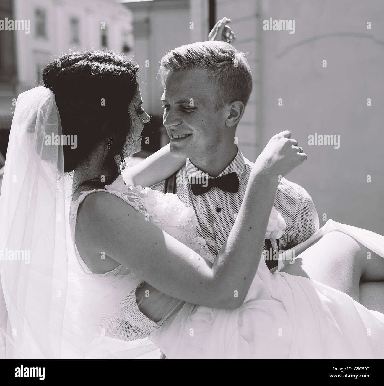 Groom carries bride in arms hi-res stock photography and images - Alamy