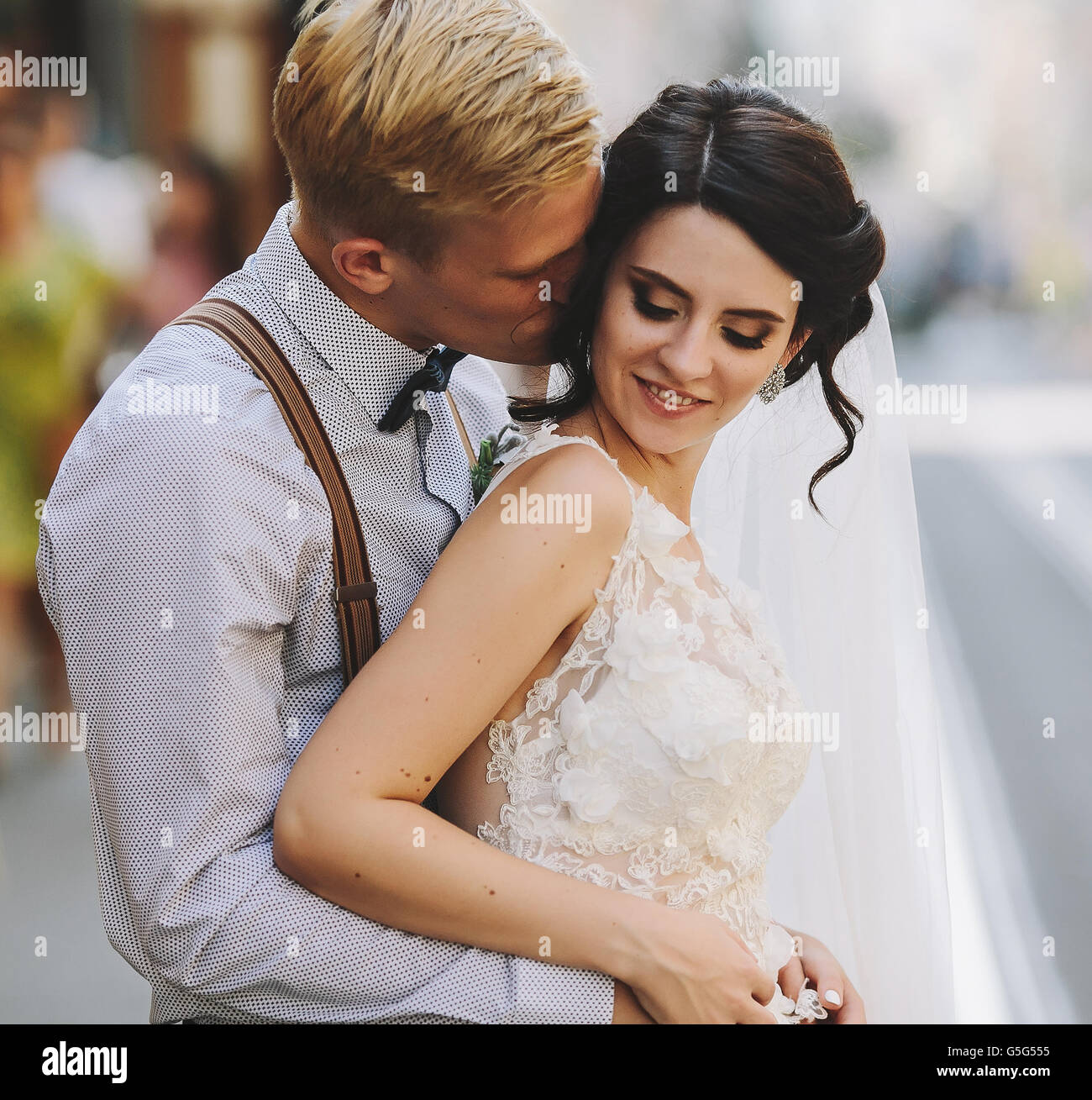 Groom hugs bride Stock Photo - Alamy