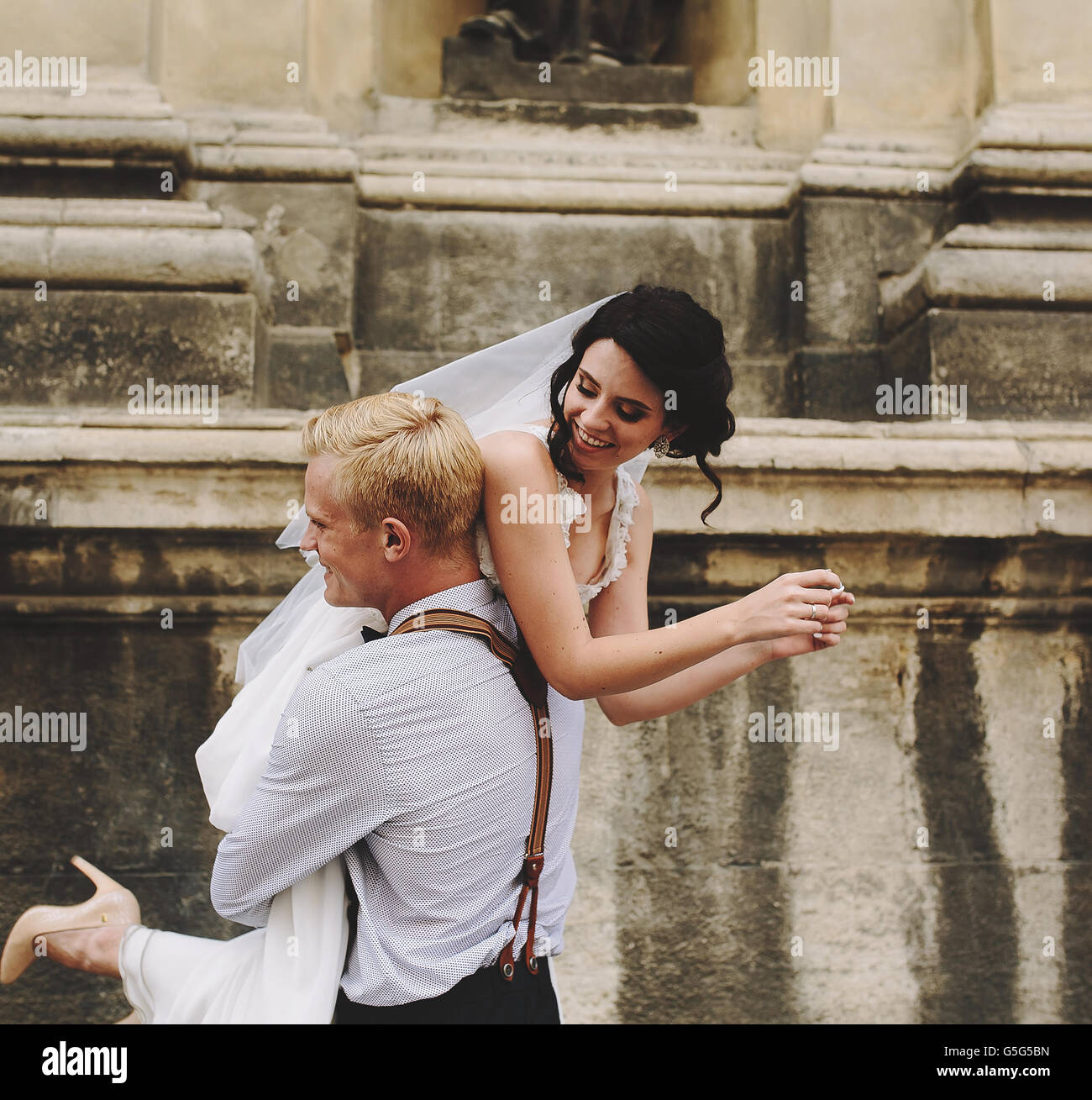 groom carries bride in his arms Stock Photo - Alamy