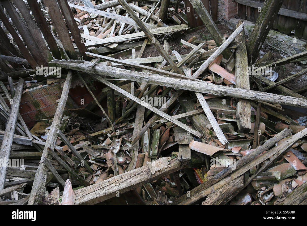 wooden planks and rubble and the ruins of the house completely ...