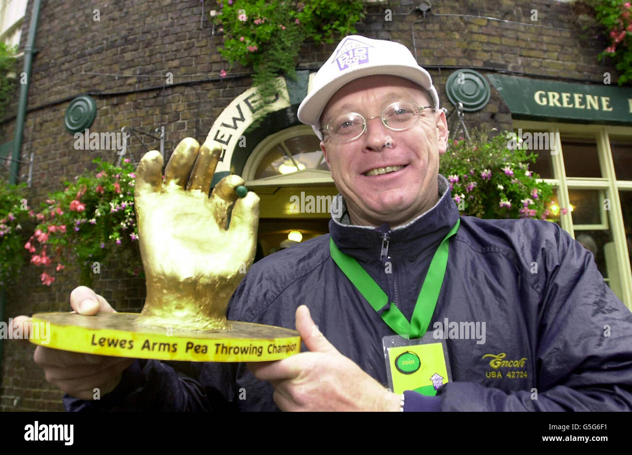 Mike deacon proudly holds the world pea throwing championship trophy hi ...