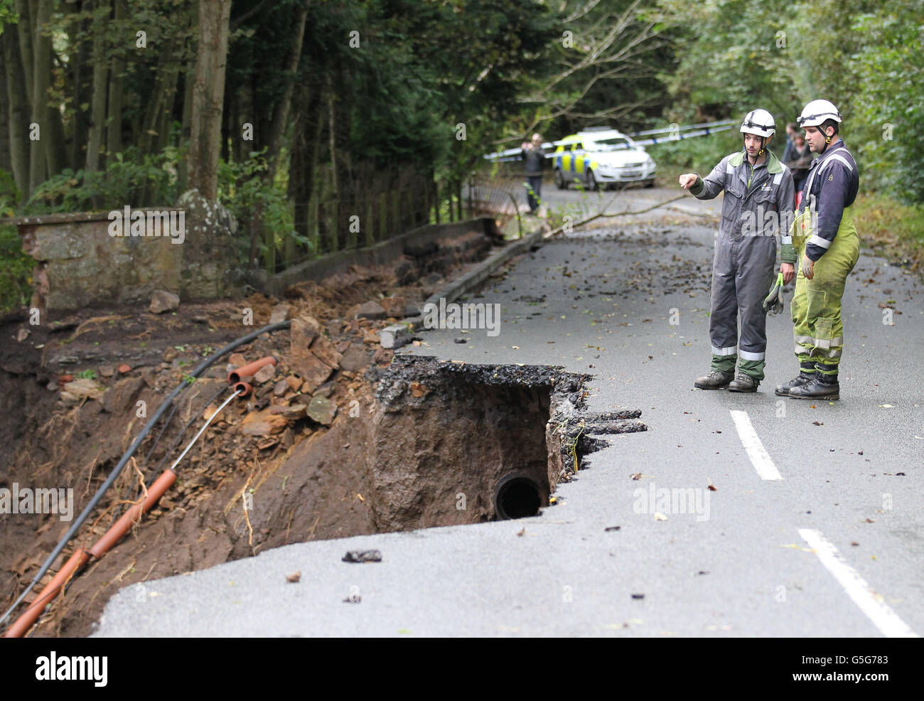 Workmen view the damage caused in Dura Den in Fife after heavy rainfall ...