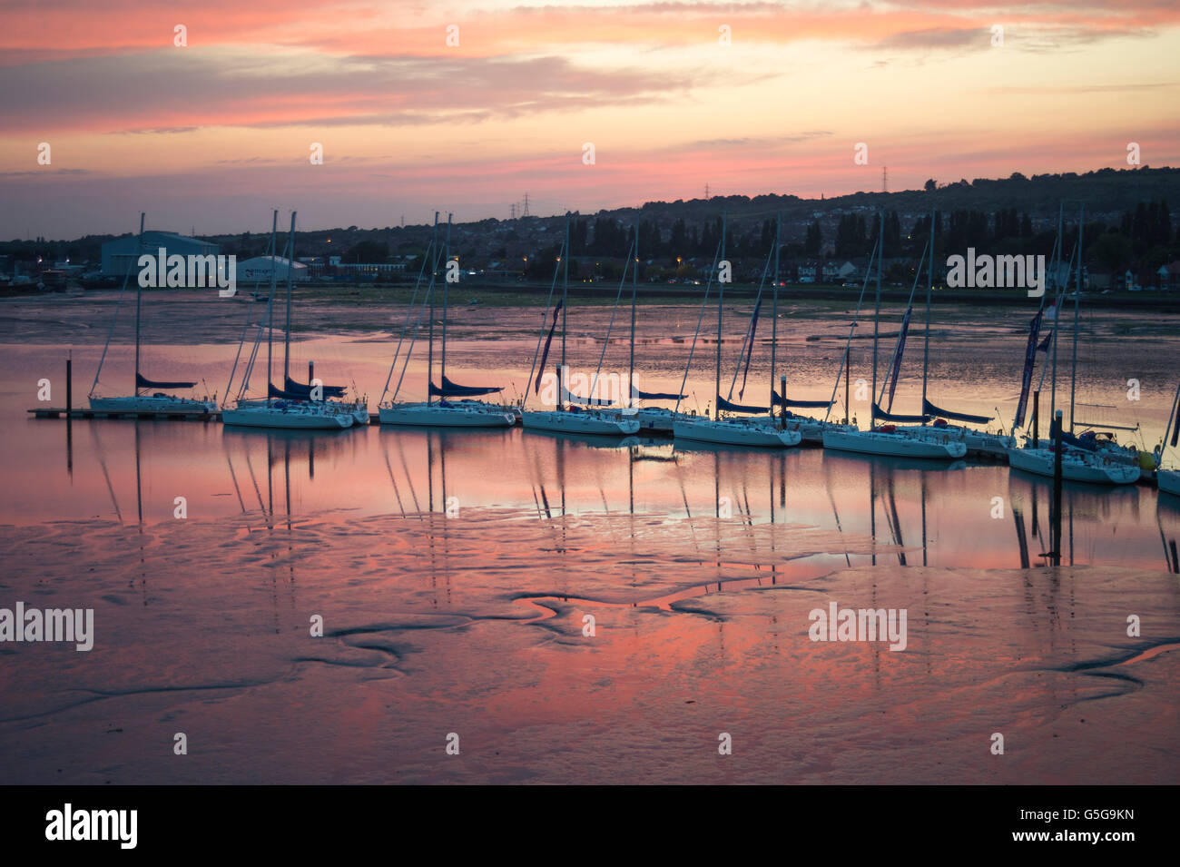 yachts moored on a pontoon at Port Solent Marina at sunset, Hampshire ...