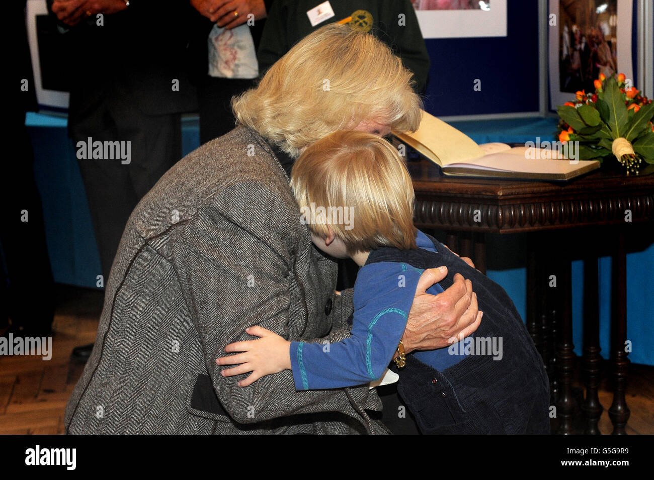 The Duchess of Cornwall is greeted by her grandchildren, twins Gus and ...