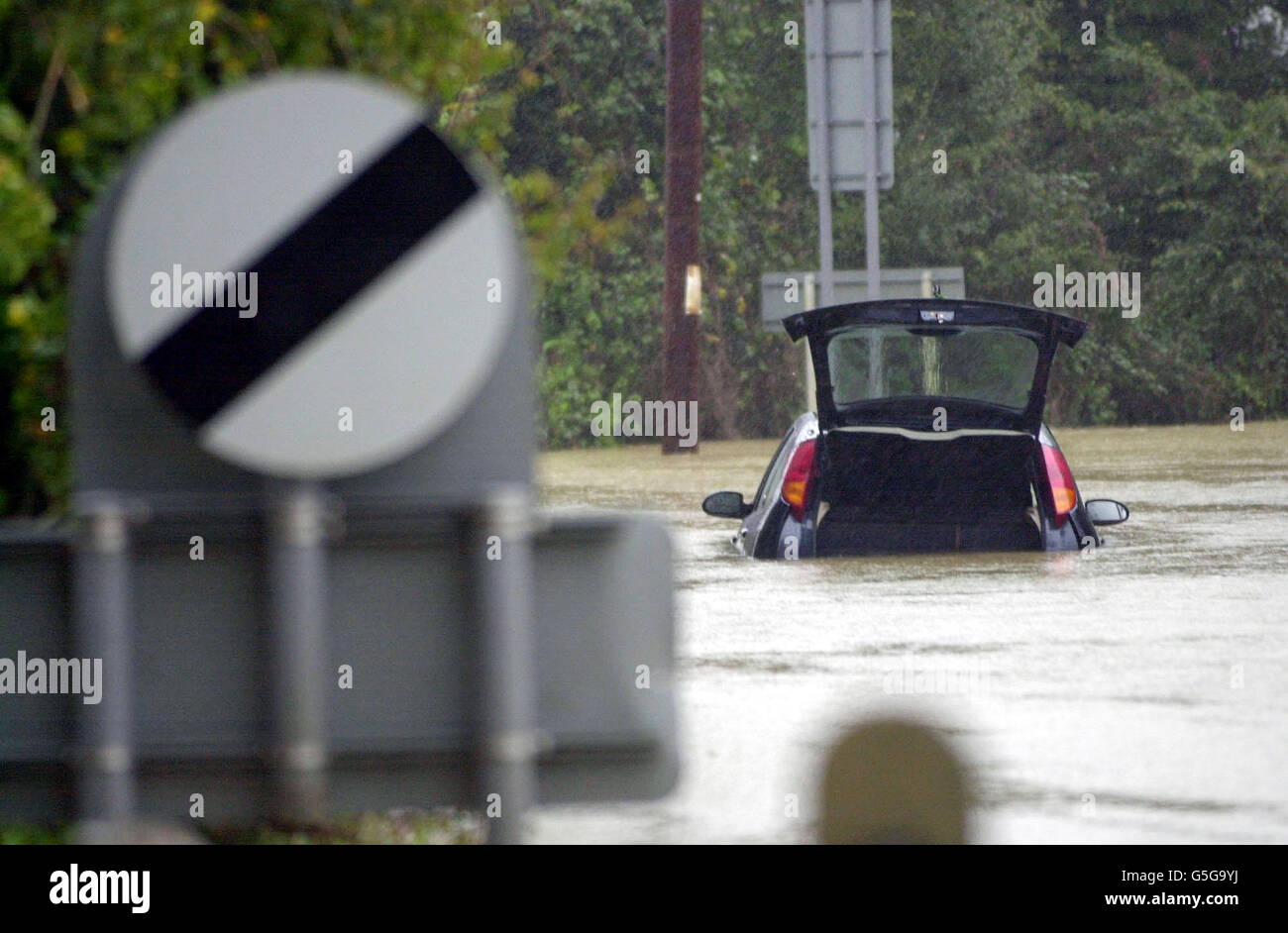 A car is caught in flooding in Caldecote, Cambridgeshire, as the ...