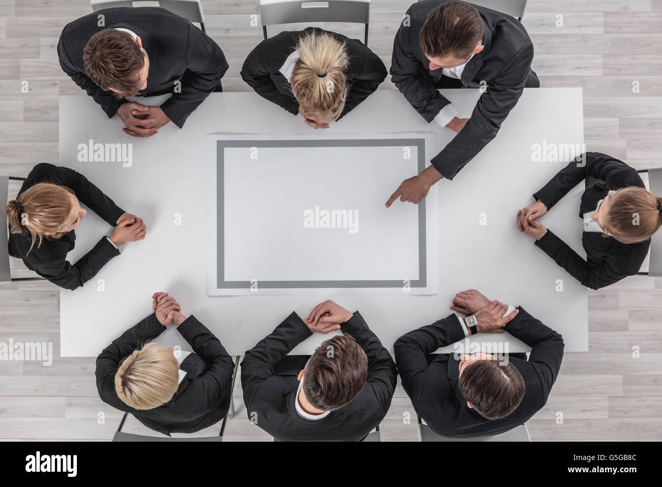 Diverse business people sitting around the table on a meeting Stock ...