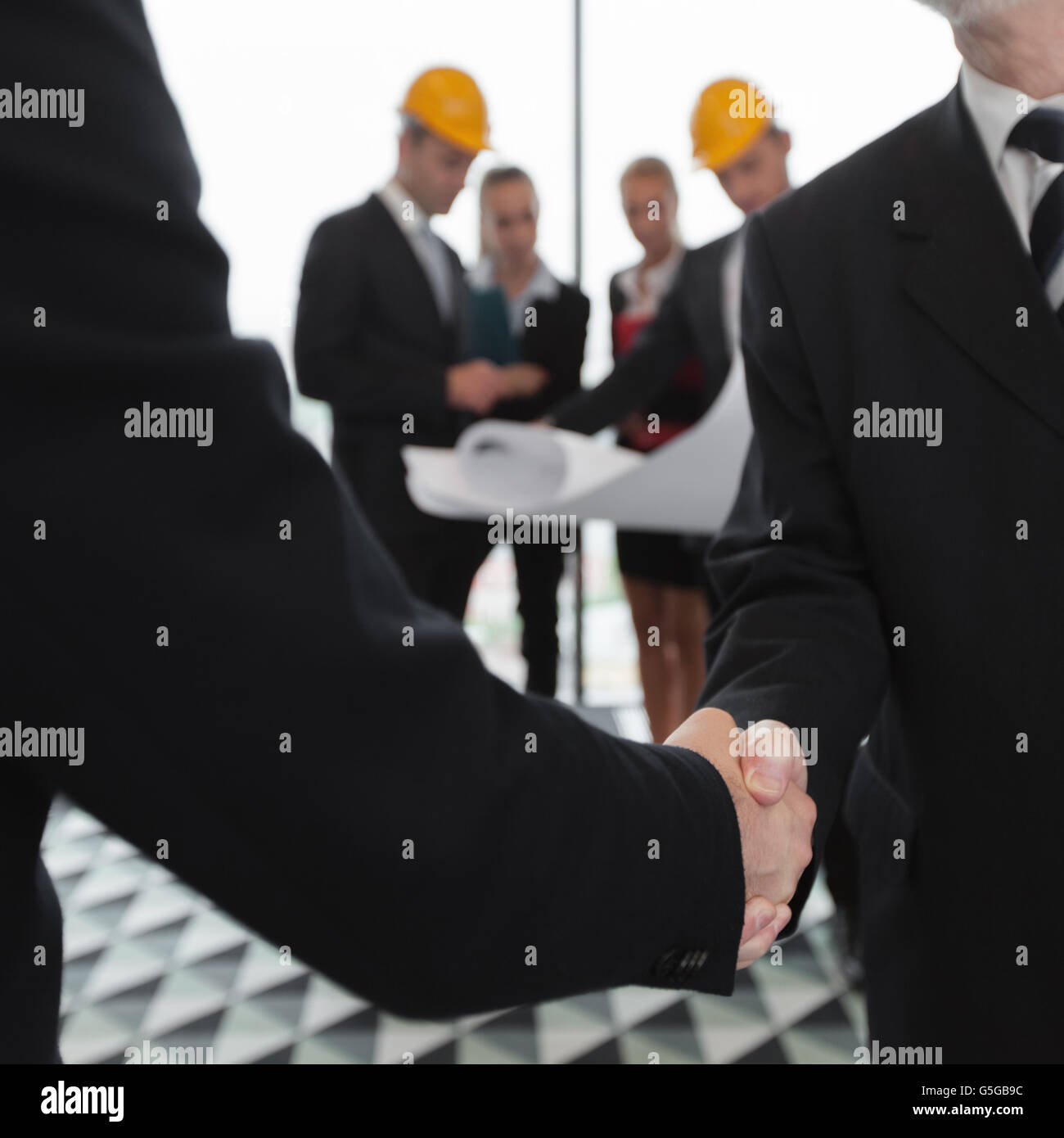 Handshake of architect and investor, business team with blueprint on ...