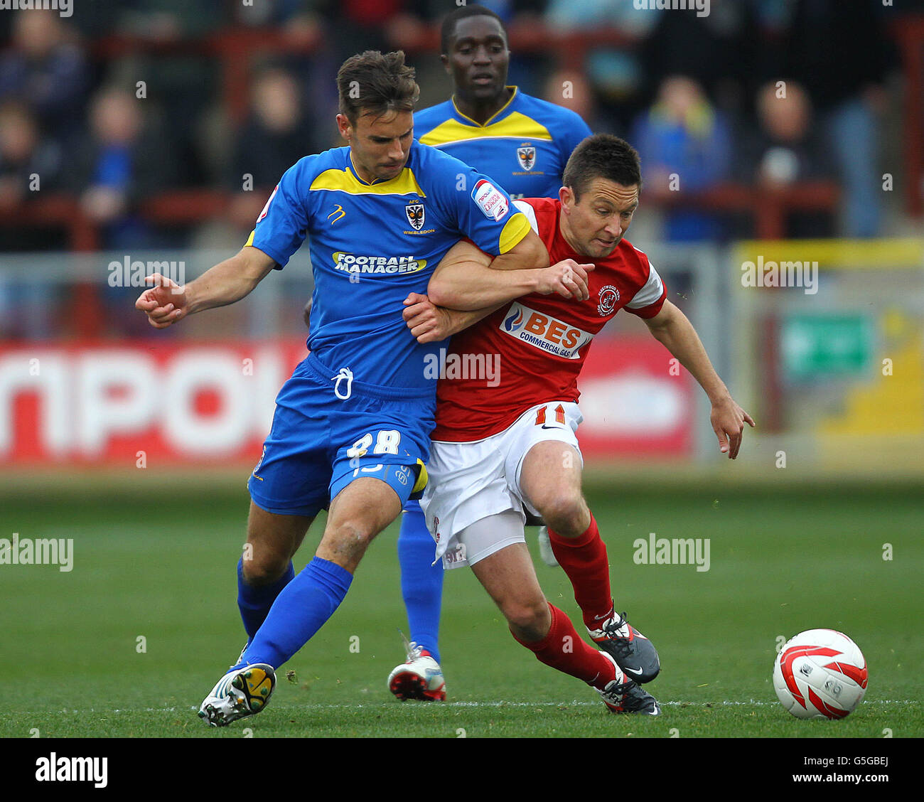 Fleetwood Town's Barry Nicholson and AFC Wimbledon's Steven Gregory ...