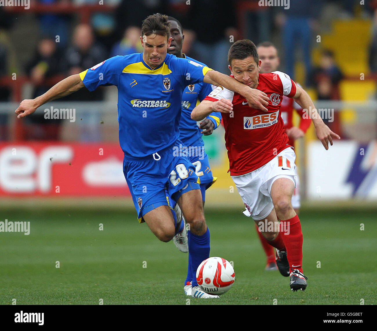 Fleetwood Town's Barry Nicholson and AFC Wimbledon's Steven Gregory ...