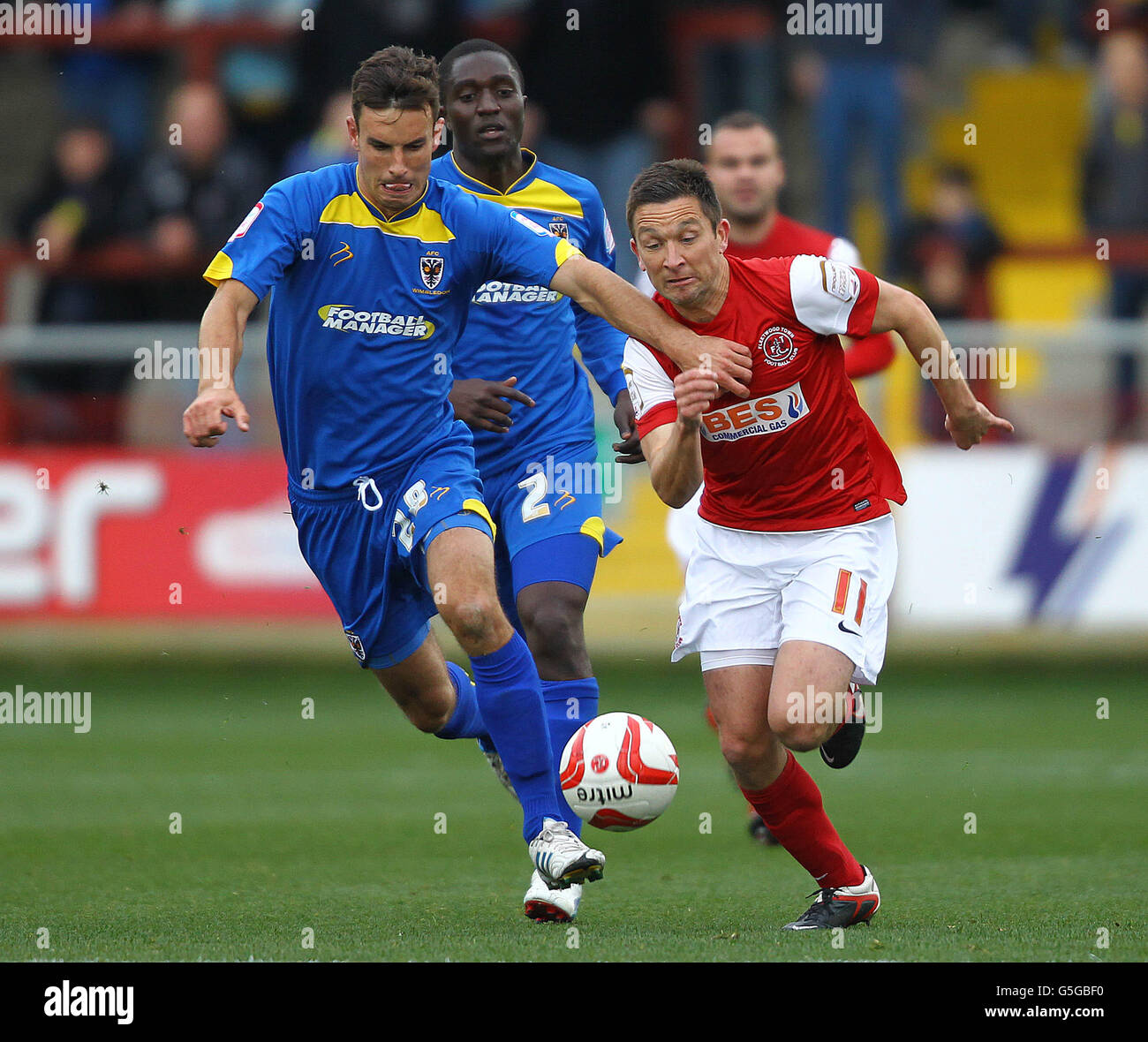 Fleetwood Town's Barry Nicholson and AFC Wimbledon's Steven Gregory ...