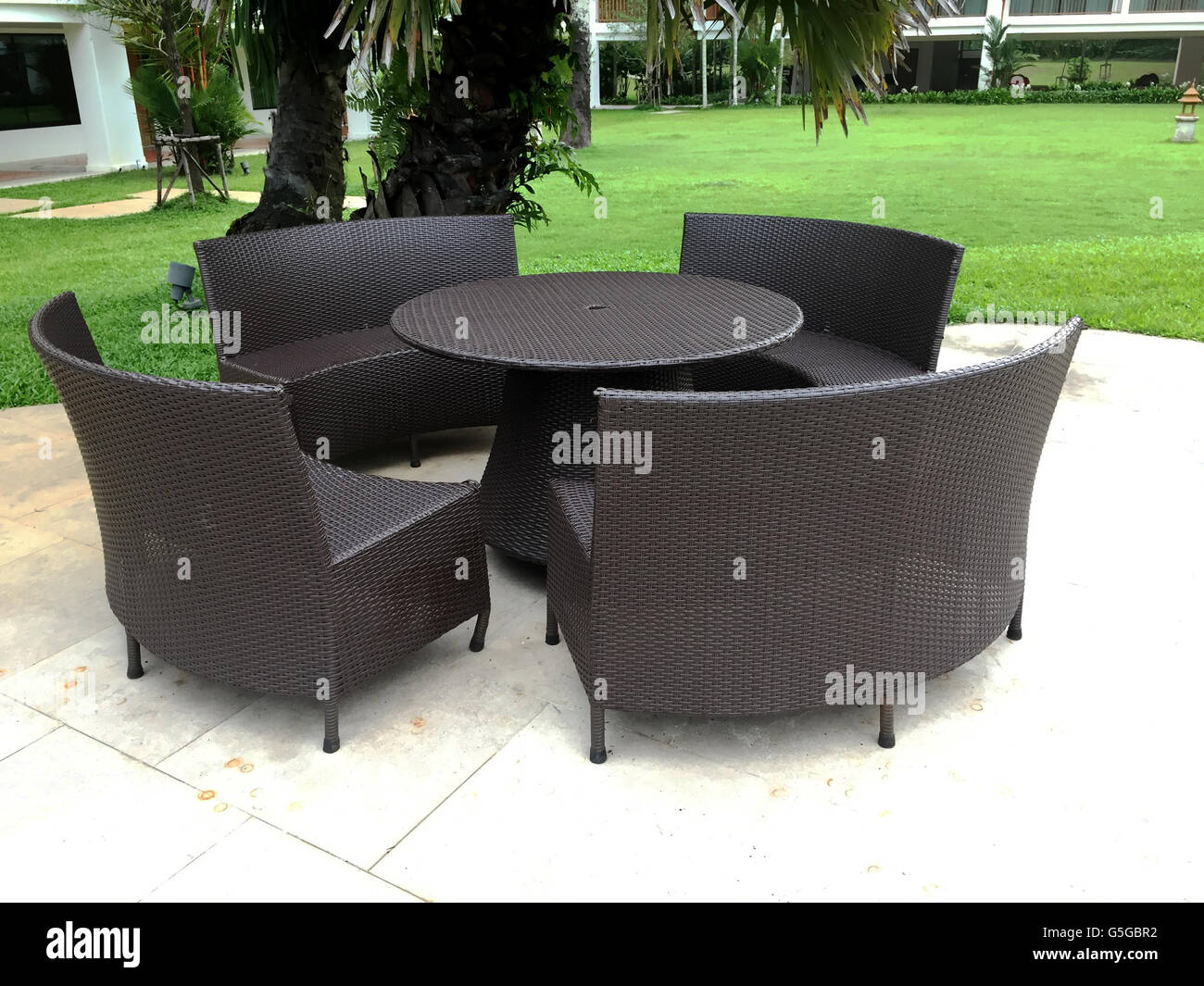 Weave table and chairs for relax at the garden Stock Photo - Alamy