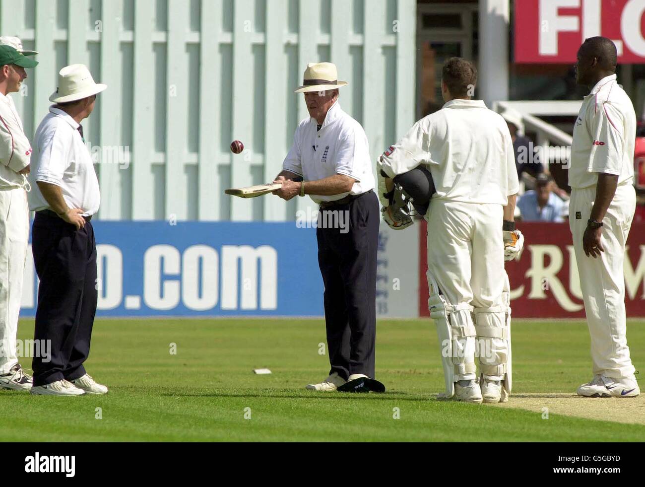 Umpire Bob White (centre) tests a new replacement ball with (l-r ...