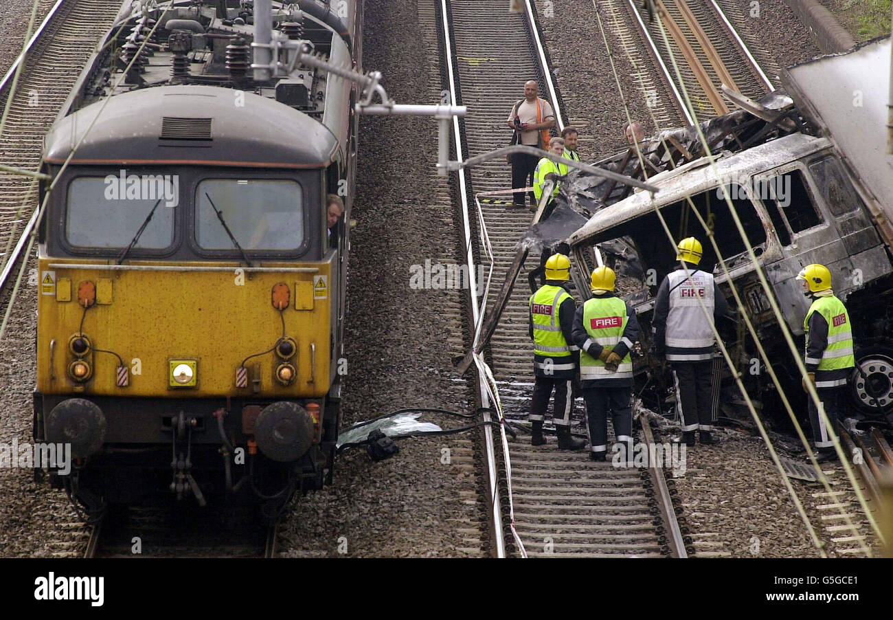 A commuter train passes the scene where a lorry came off a road and on ...